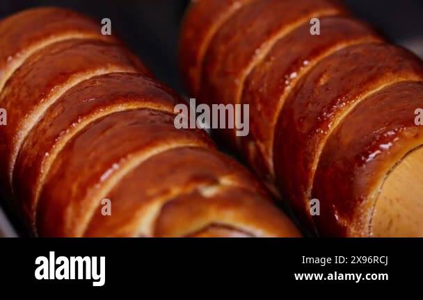 Two rolls of bread baking by roasting, displaying a golden, crispy ...