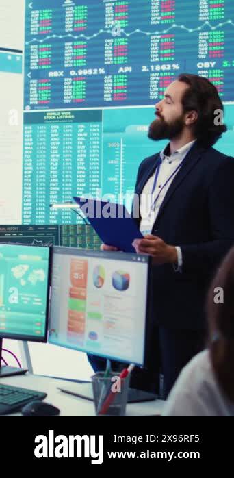 Vertical Video Chief executive officer reviews data shown on big ...