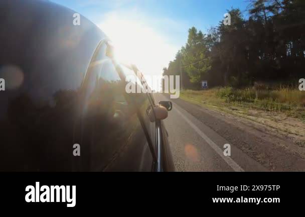 Young man moving on black automobile and holding his right elbow on ...