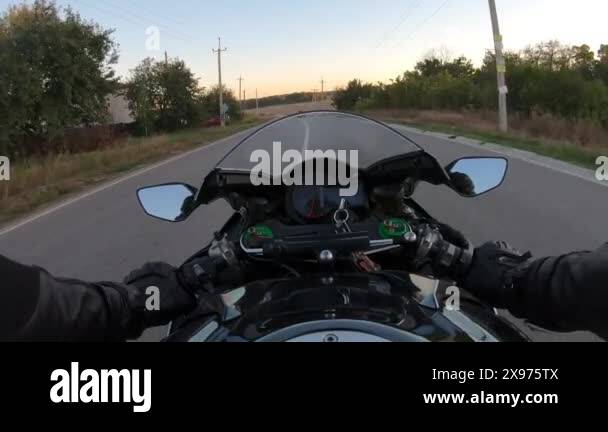 Biker racing his motor bike during summer journey. Point of view of a ...