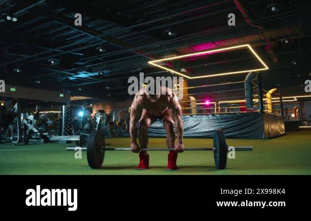 A professional bodybuilder is demonstrating dedication, strength, and ...