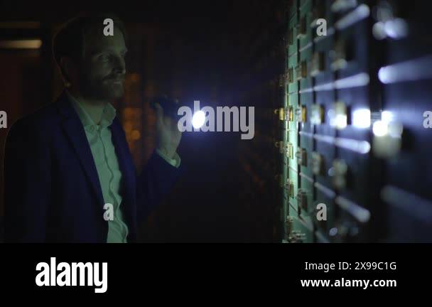 A man explores a dimly lit room with storage boxes using a flashlight ...
