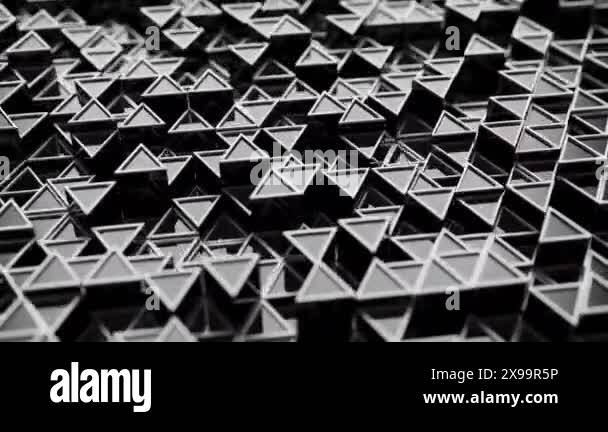 Looping animation of a group of black plastic triangular geometric ...