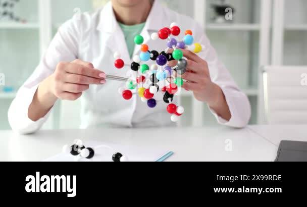 Scientist looks at model of molecular structure. Molecule definition ...