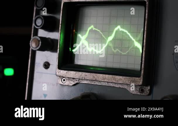 A vintage oscilloscope screen displays a vibrant green signal waveform ...