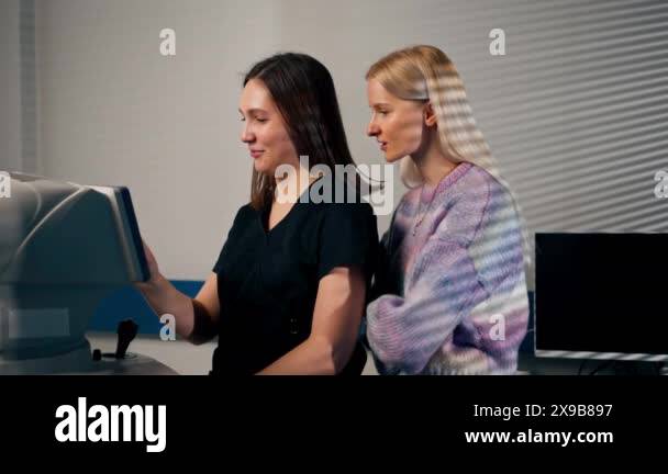 in an ophthalmology clinic a female doctor shows the patient and tells ...