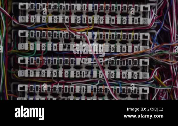 Inside a PABX telephone booth that has a number of connecting cables in ...