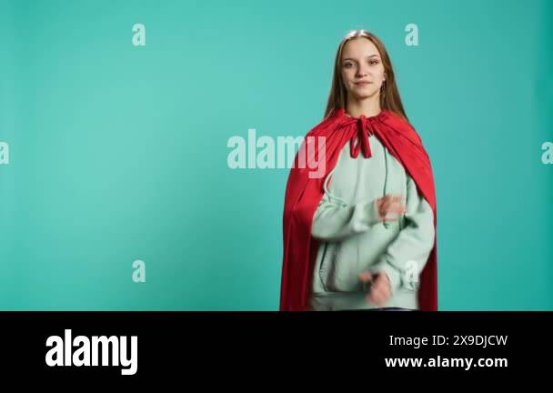 Radiant woman grinning while portraying confident superhero wearing red ...