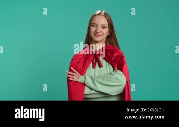 Radiant woman grinning while portraying confident superhero wearing red ...