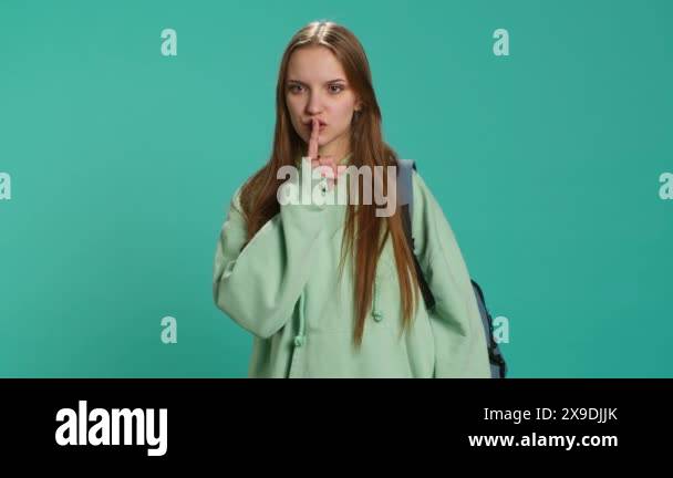 Stern woman doing shushing hand gesturing, irritated by noise, having ...