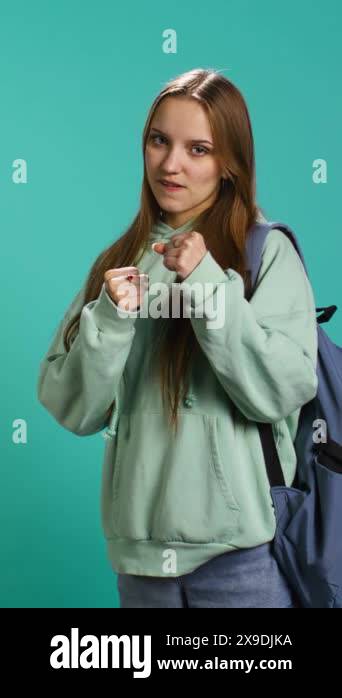 Vertical video Woman doing fighting stance, pretending to do boxing ...