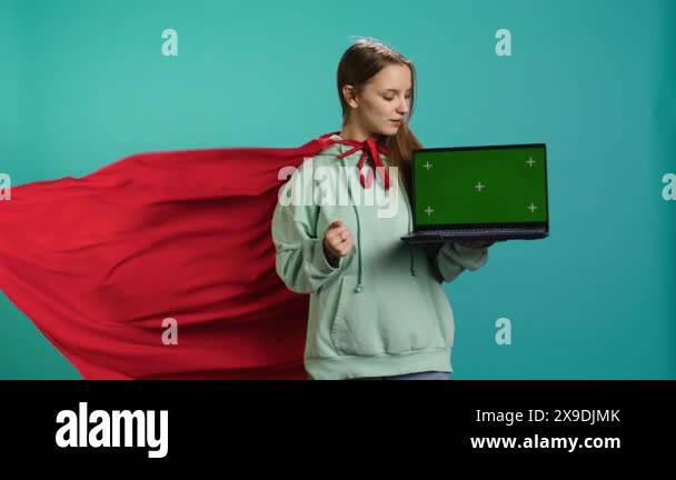 Young girl wearing superhero costume presenting and talking about green ...