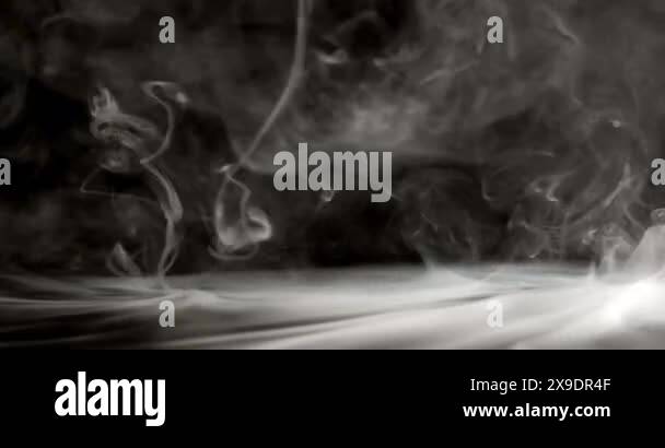 A close-up captures smoke forming intricate and fluid patterns as it ...