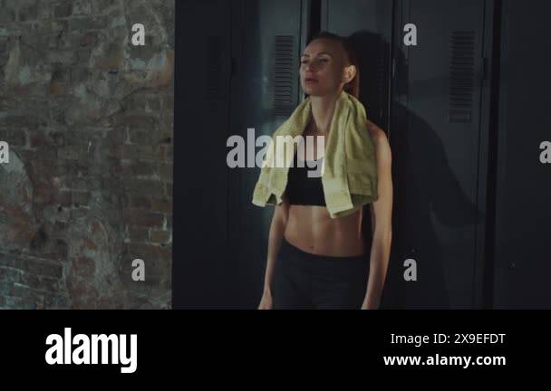 Woman resting after intense boxing workout with towel over her ...