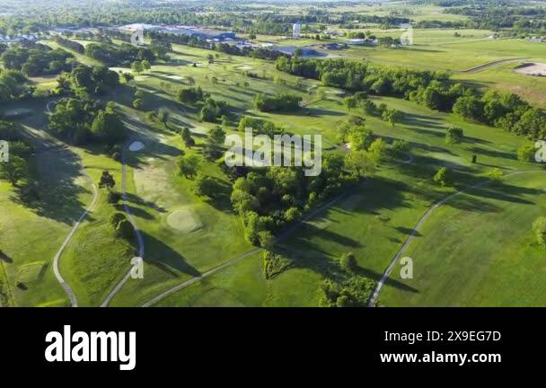 Flyover cart path in 18 holes golf course, lavish greens sloping ...