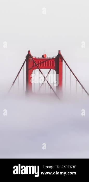 Vertical Screen: The Golden Gate Bridge emerges from dense fog, showing ...