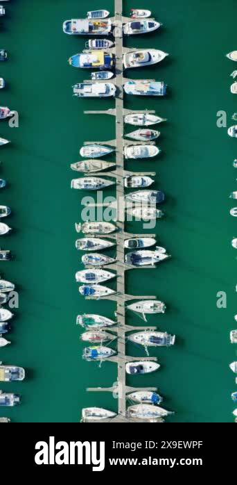 Vertical Screen: An aerial view of a marina with turquoise water shows ...