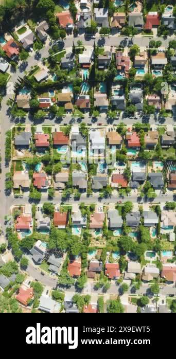 Vertical Screen: View of a suburban neighborhood with houses, pools ...
