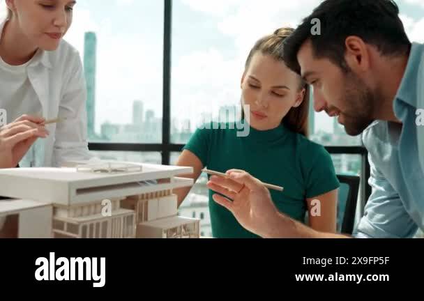 Architect engineer team working together to analyze house model ...