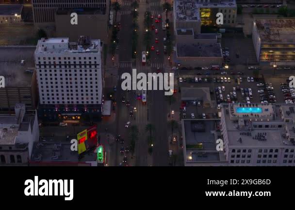 Lively streets and illuminated buildings of new orleans at dusk. City ...