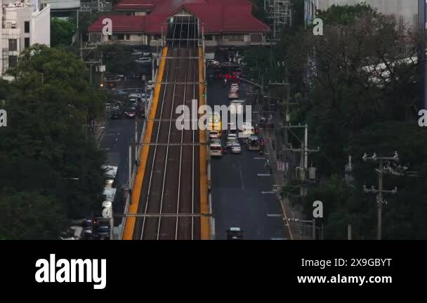 Busy Manila train station with vehicles in urban streets, showcasing ...