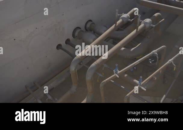 Tubes conducting technical water connected to sewer in pit. Installing ...