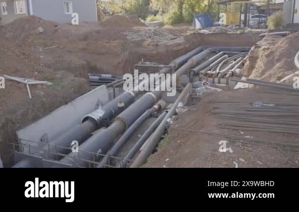 Pipes of water supply system under construction laid in trench. City ...