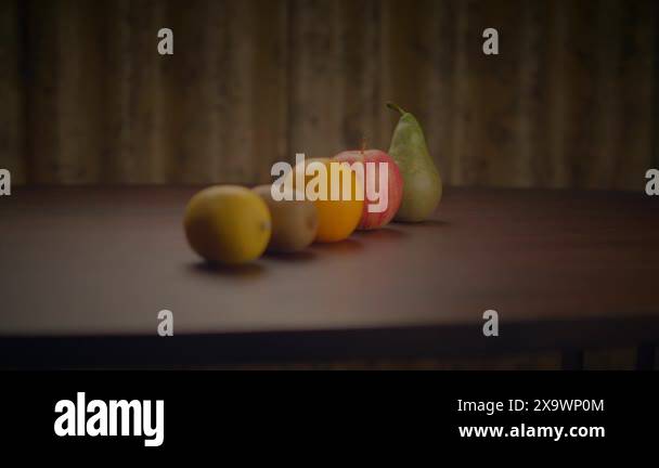 A lineup of various fruits placed on a hardwood table, creating a still ...