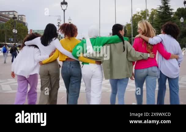 Back view of group young only female friends strolling embracing ...