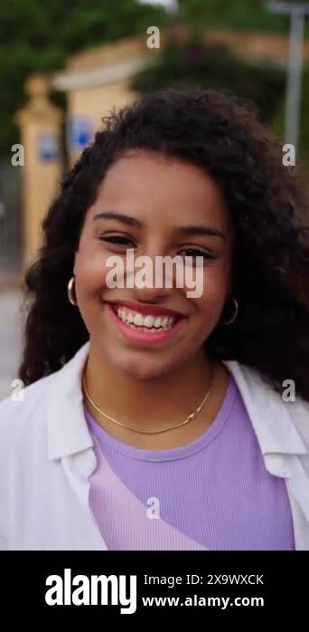 Vertical Beautiful happy African American girl. Portrait of cheerful young Latina woman outdoors ...