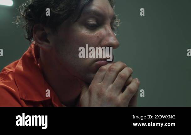 Close-up shot of face of young male Caucasian homicide suspect in ...