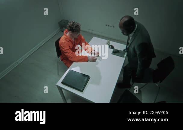 Full top shot of African American male police officer bringing murder ...