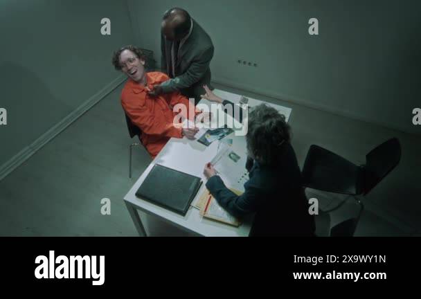 Full top shot of diverse federal agents interrogating murder suspect, looking at crime scene ...