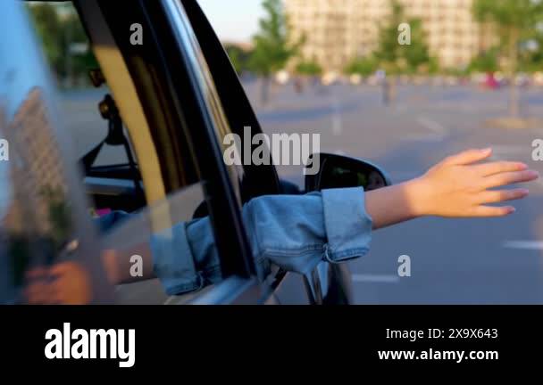 Free kid puts her hand out car window sitting in front seat. Travel ...