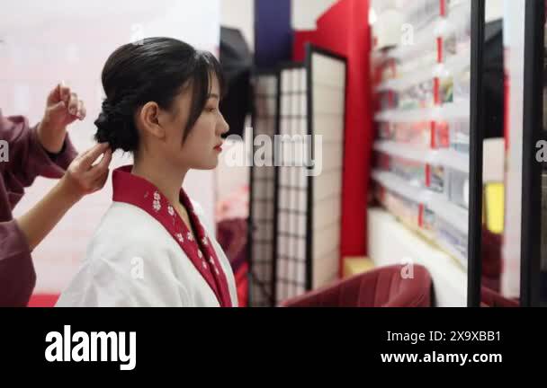 A young woman in her twenties, wearing traditional Ryusou, is having ...