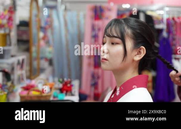 A young woman in her twenties, wearing traditional Ryusou, is having ...