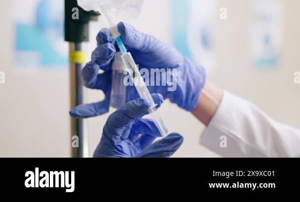 Hospital, IV drip and hands of nurse with syringe for medicine ...