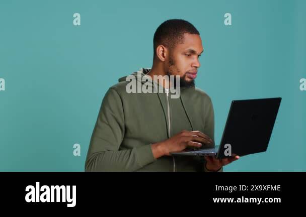 Man typing on laptop keyboard, checking emails, feeling overjoyed after ...