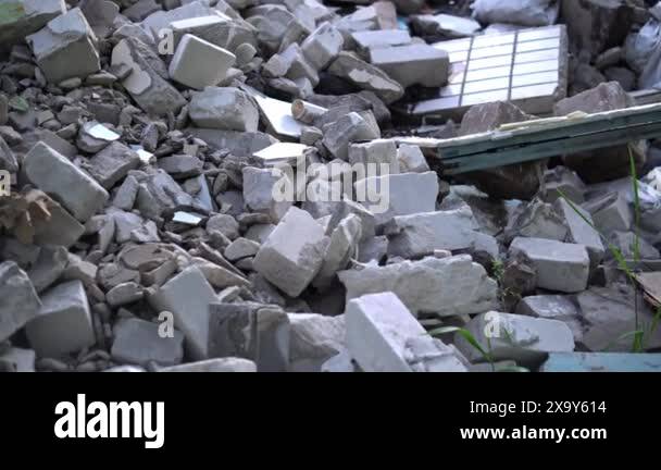 A close-up view of a construction waste pile reveals the shattered ...