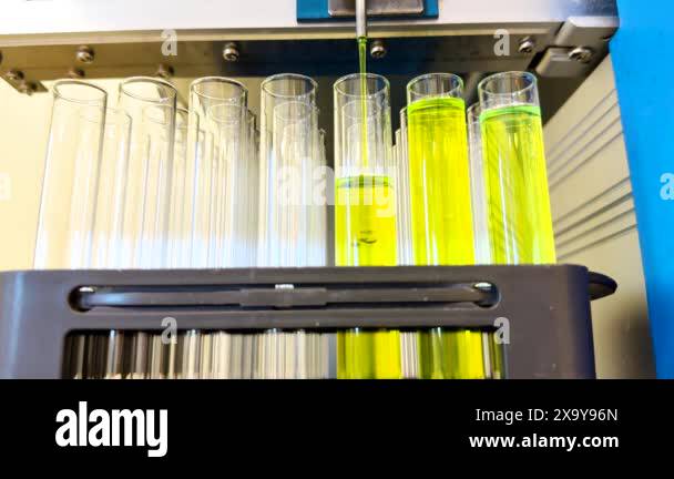 Green fluorescent compound is separated in automated machine. test tube ...