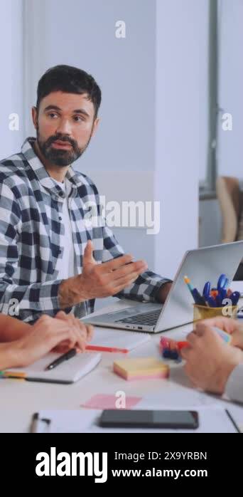 Team members collaborate and exchange handshakes during office meeting ...