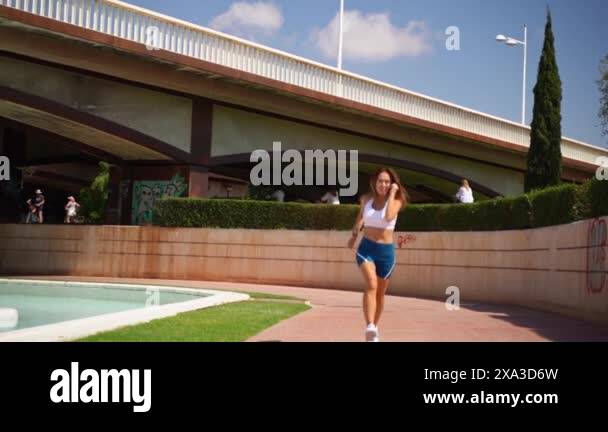 Asian oriental adult woman jogger in sportswear running workout lace up sunny morning urban high ...