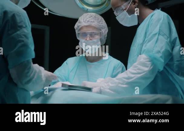 Waist up of Caucasian mid-adult female surgeon in face mask and eyewear ...