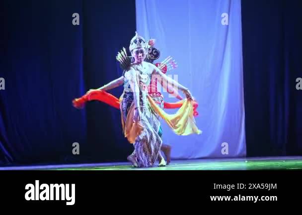 Two performers in traditional Indonesian dance costumes performing on ...