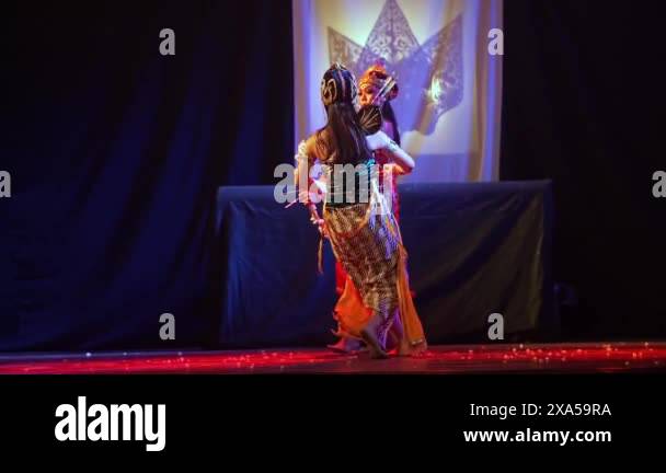 Two dancers in traditional attire performing a classical dance on stage ...