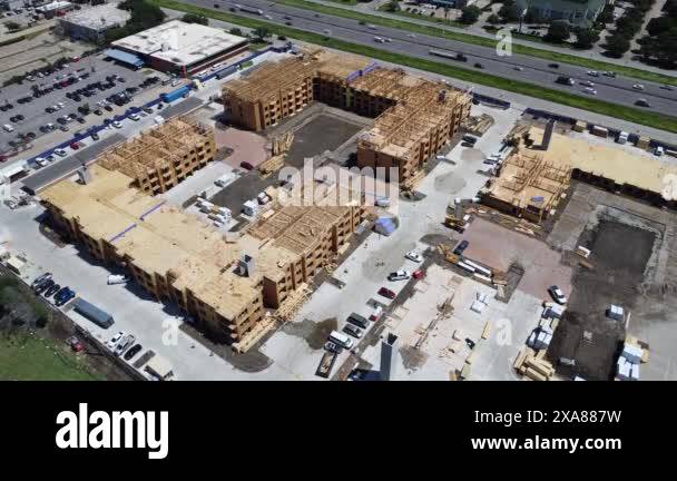 Excavator, crane, heavy equipment and workers at apartment complex ...