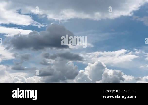 Timelapse captures the transition of white clouds in a blue sky as they ...