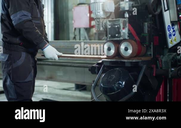 Industrial factory at the production zone factory worker using a long ...