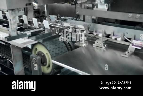 Manufacturing line at medical factory. Robotic arm put medicine package ...