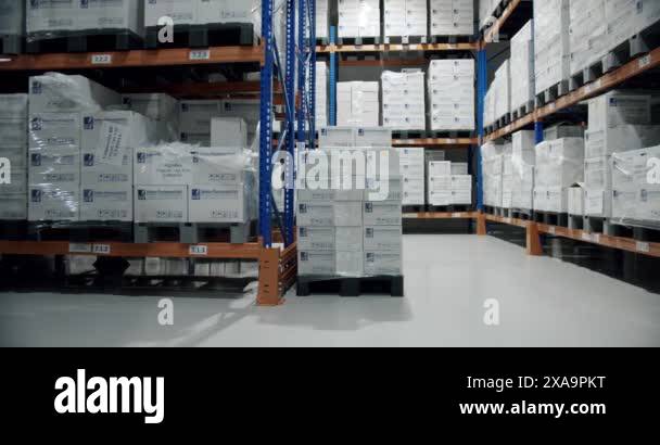 Logistics center interior full of racks with with large number packs ...